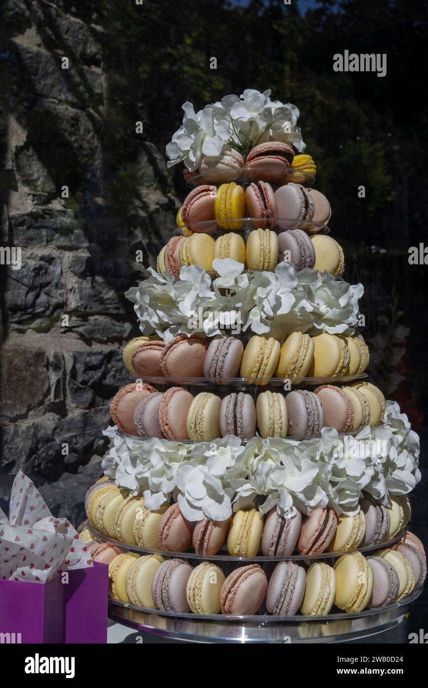 A wedding pyramid of French meringue macarons. Pink, yellow, purple and ...