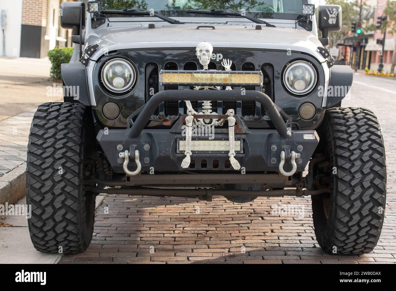A grey Jeep Wrangler parked on a street. The rugged 4x4 suv has a ...