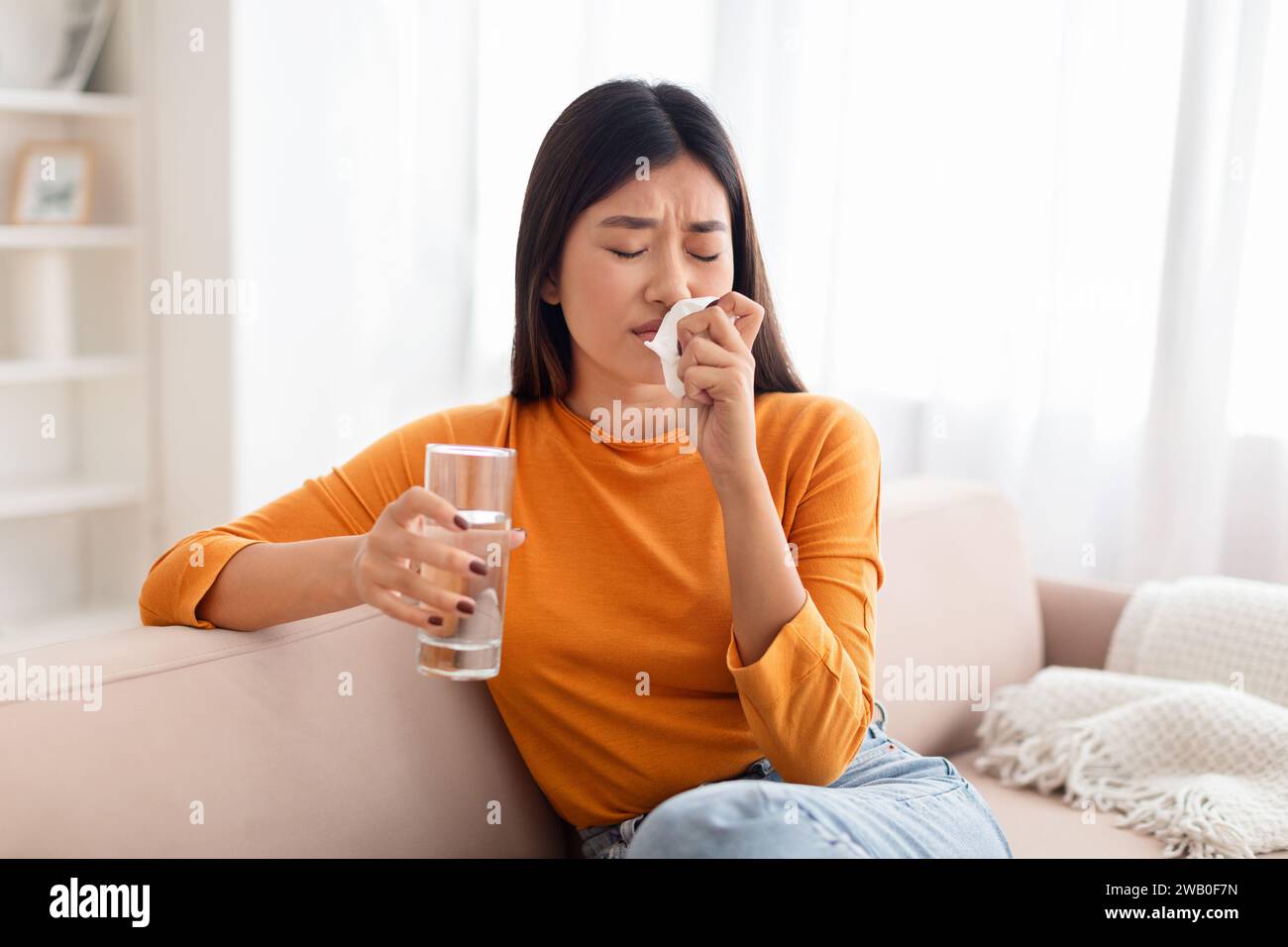 Sick millennial asian woman suffering from nausea at home Stock Photo ...