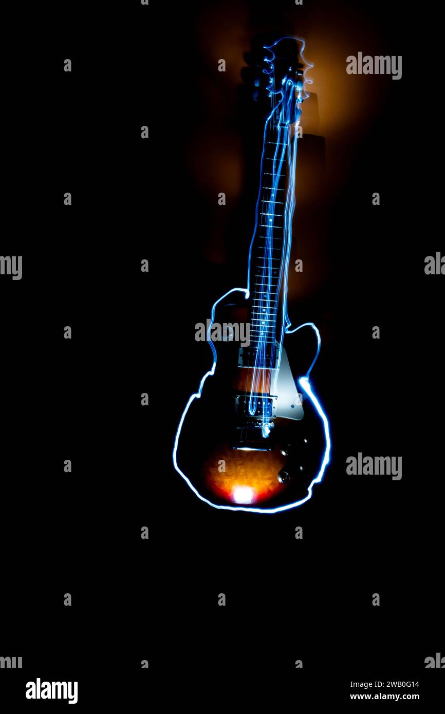 A rock and roll guitar outlined in light streaks with a long, slow ...