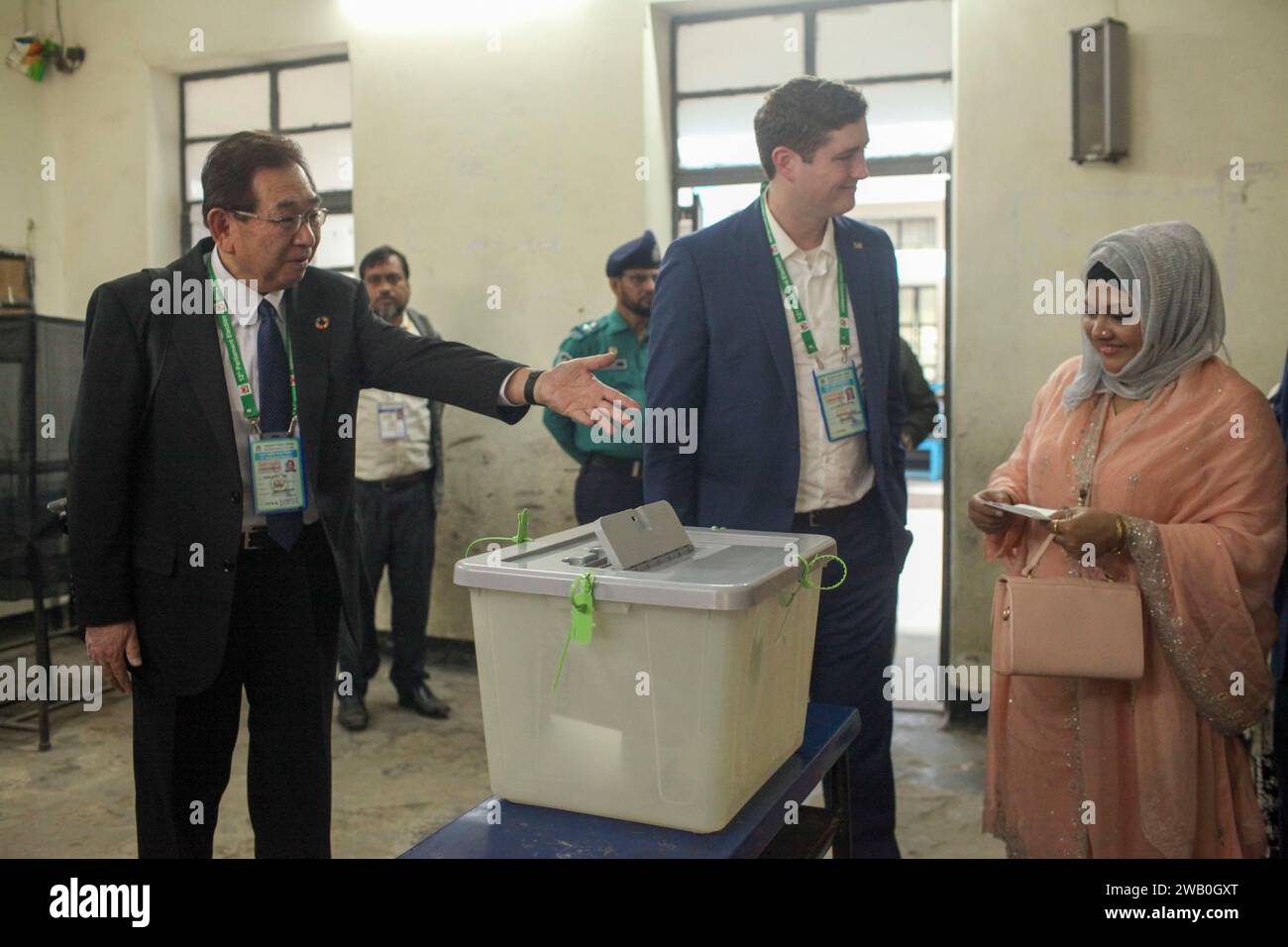 Dhaka, Bangladesh. 7th Jan, 2024. A woman (C) casts her ballot to vote ...