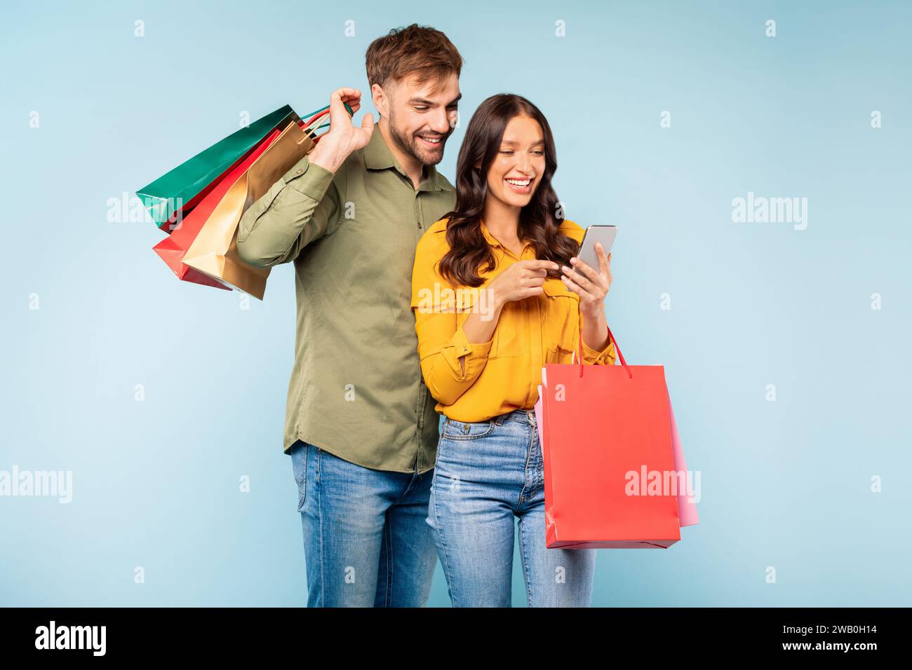 Shoppers with bags and smartphone, enjoying a day out Stock Photo - Alamy