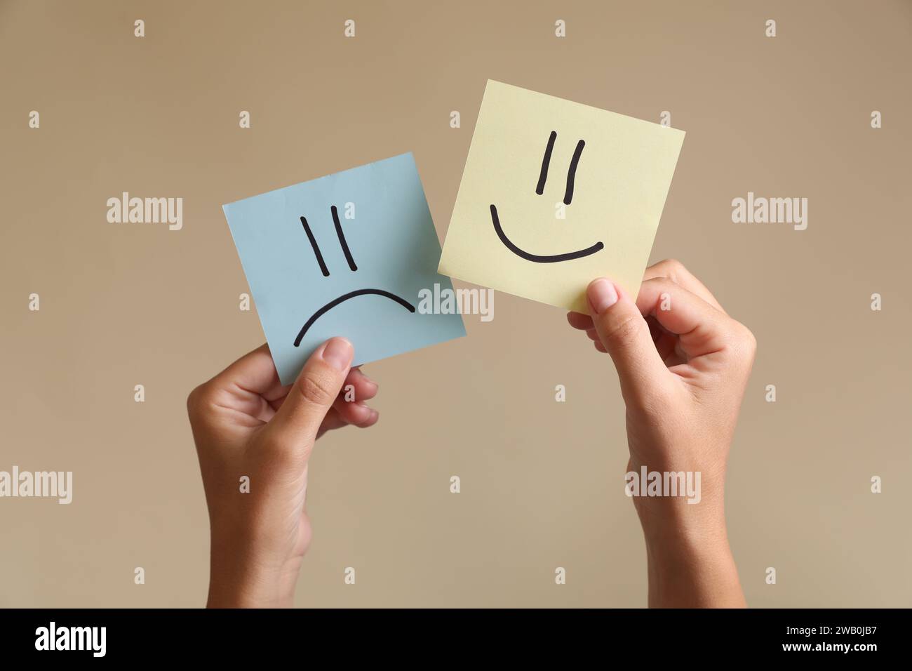 Choice concept. Woman holding papers with sad and happy emoticons on ...