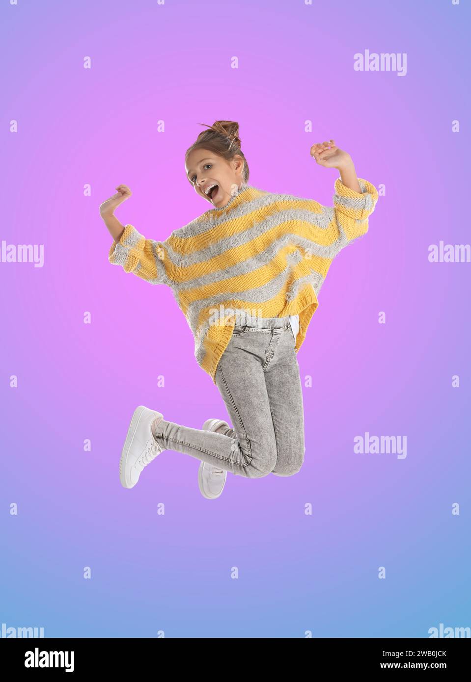 Happy cute girl jumping on color gradient background Stock Photo - Alamy