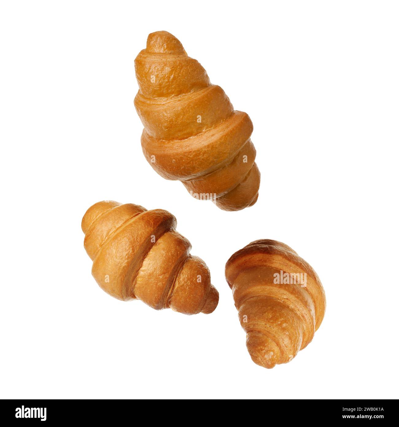 Crusty golden croissants falling on white background Stock Photo - Alamy