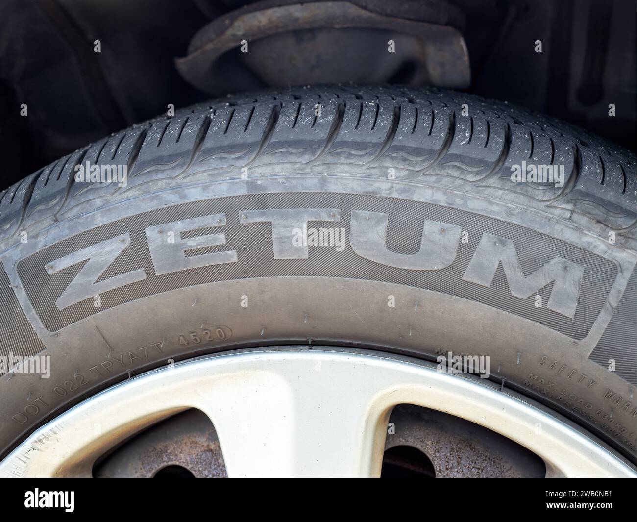 Black Zetum car tyre on rusted steel wheel. Auckland, New Zealand ...
