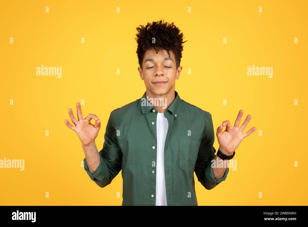 Peaceful african american guy meditating on yellow background Stock ...
