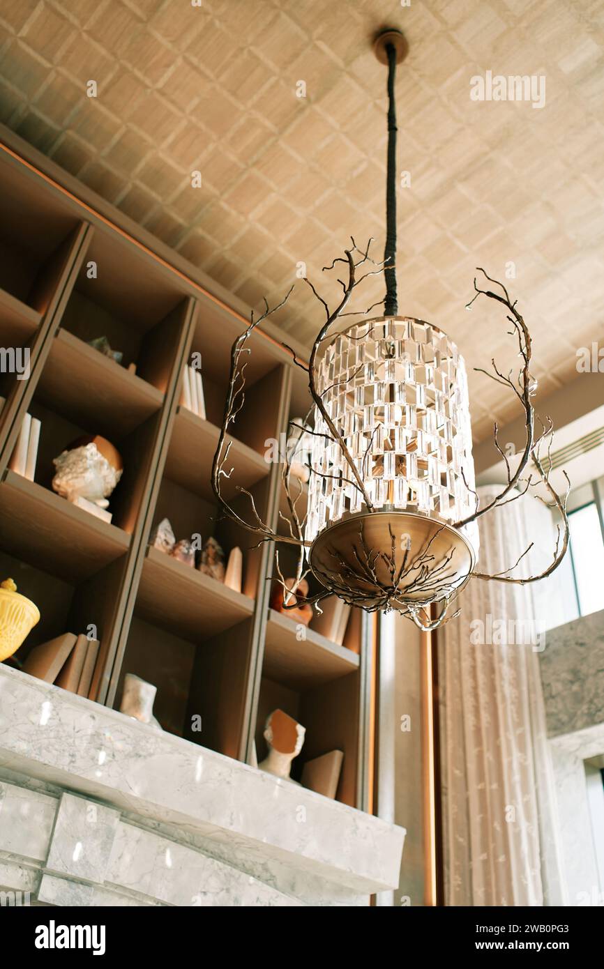 Modern chandelier with pendants and branches hanging on a high ceiling ...