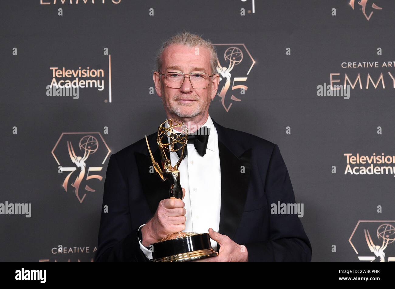 Hamish Hamilton poses in the press room with the award for outstanding ...