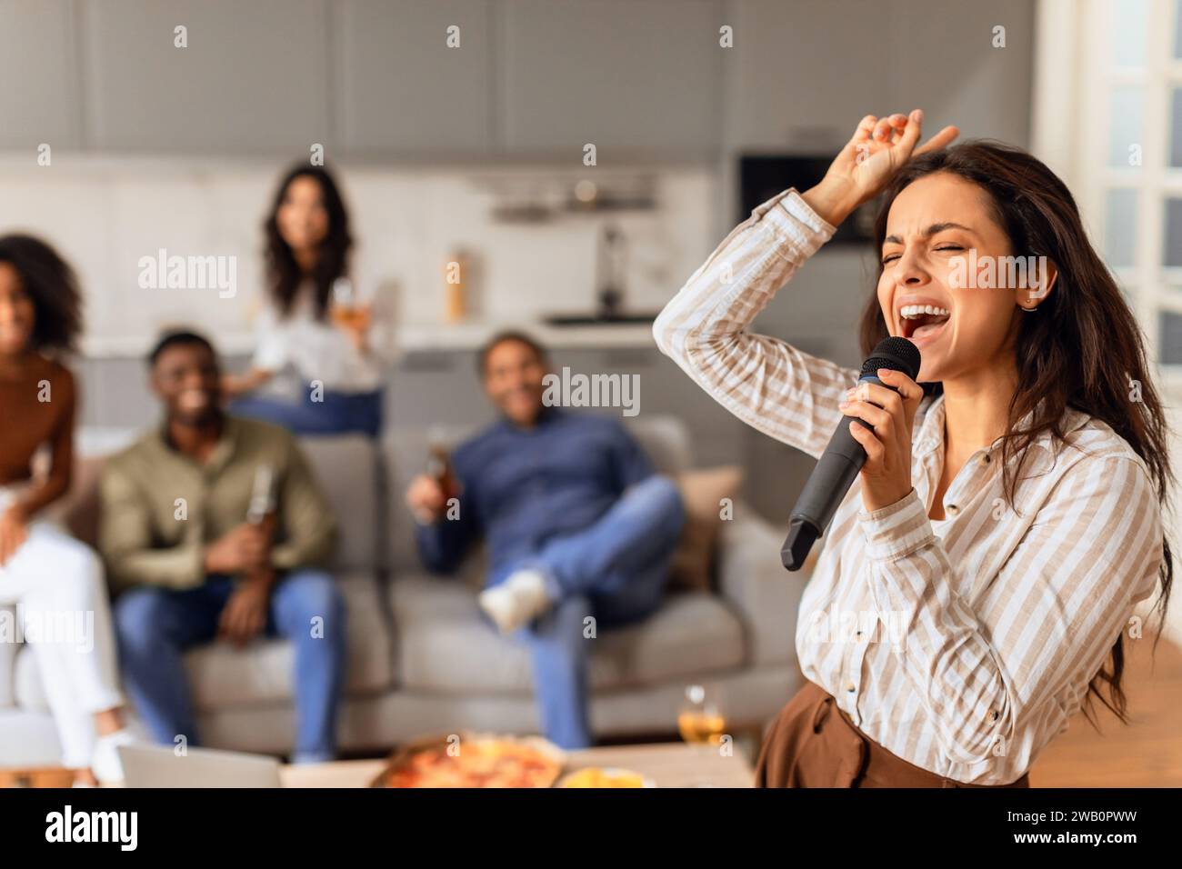 student lady singing in microphone during students' karaoke party ...