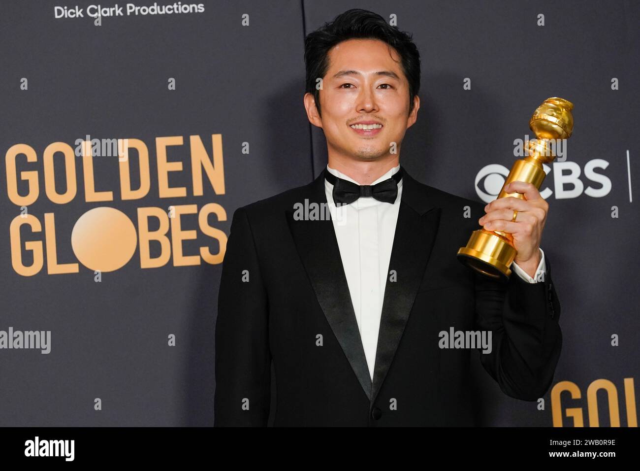 Steven Yeun poses in the press room with the award for best performance ...