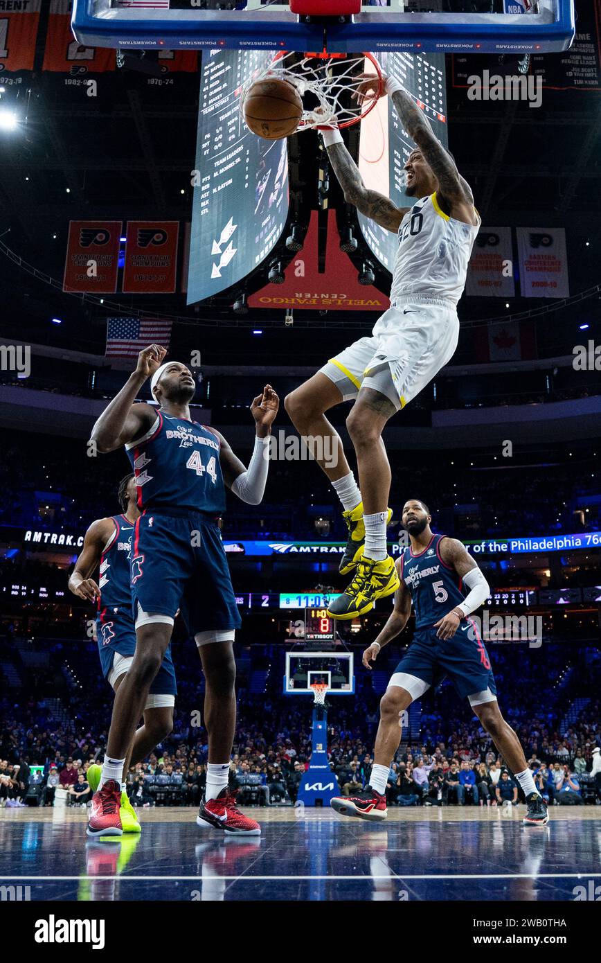 Utah Jazz's John Collins, right, dunks the ball as Philadelphia 76ers ...