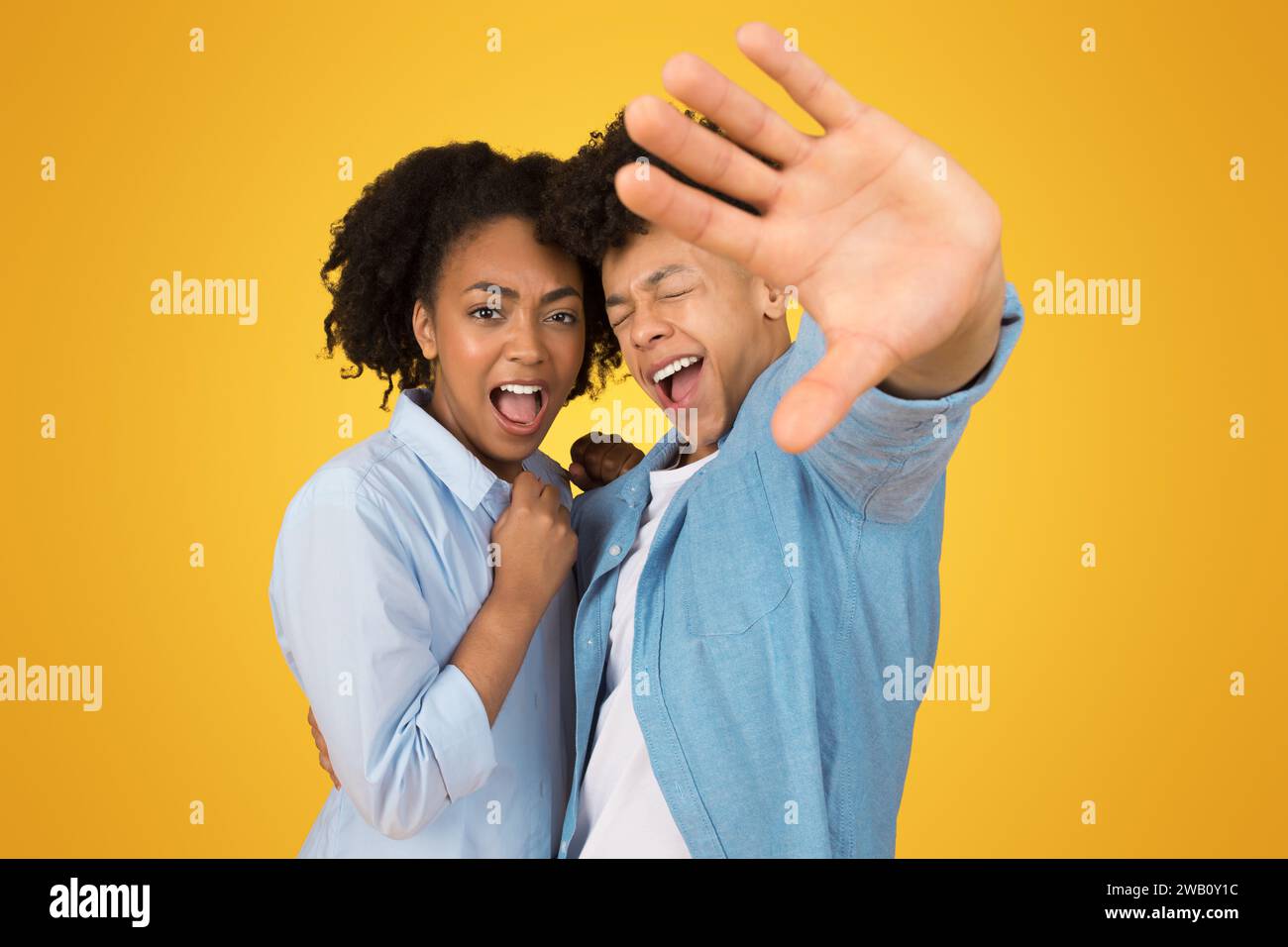 Sad excited young african american guy and woman in casual with open ...