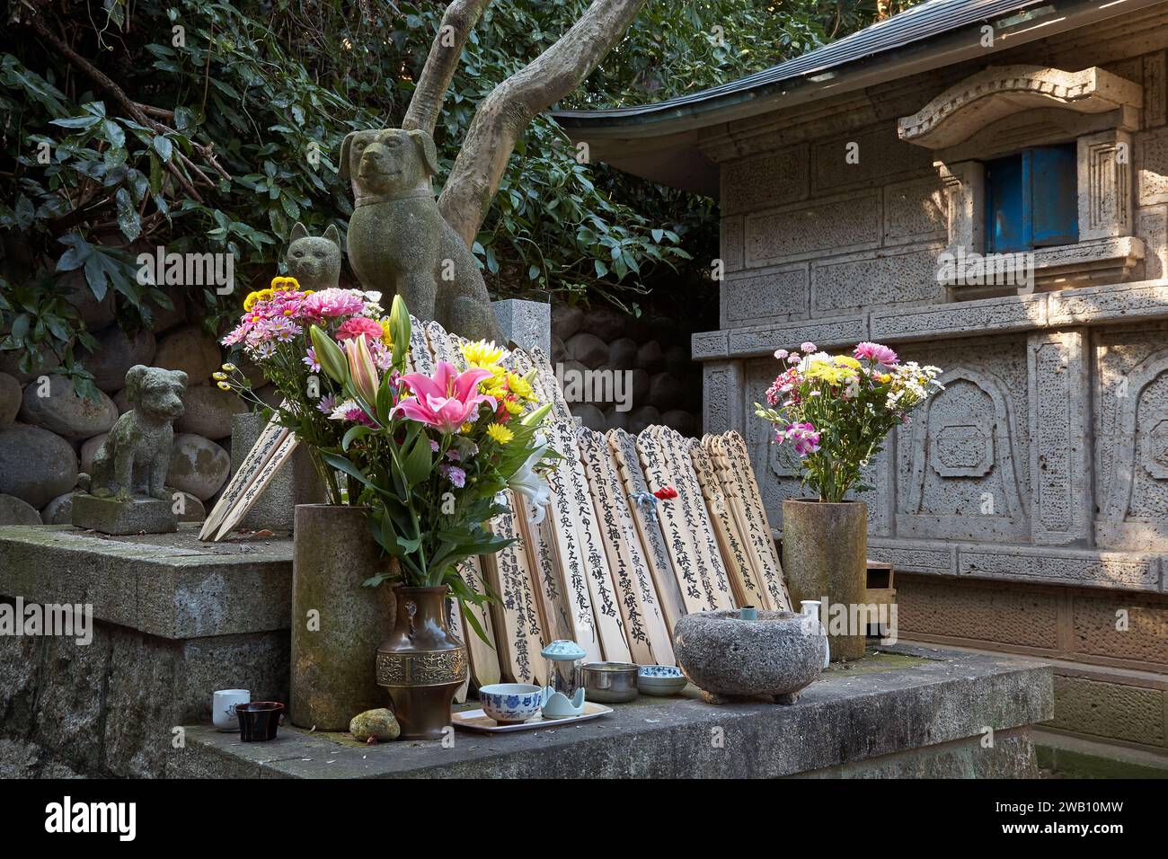 Nagoya, Japan - November 20, 2007: An altar with the statues of dogs and cat at the area which ...