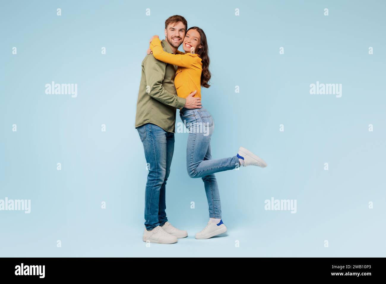 Joyful couple embracing, woman lifted in romantic hug Stock Photo - Alamy