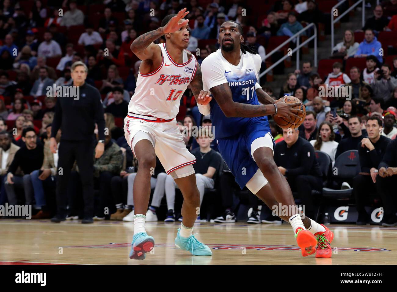 Minnesota Timberwolves center Naz Reid, right, drives to the basket ...