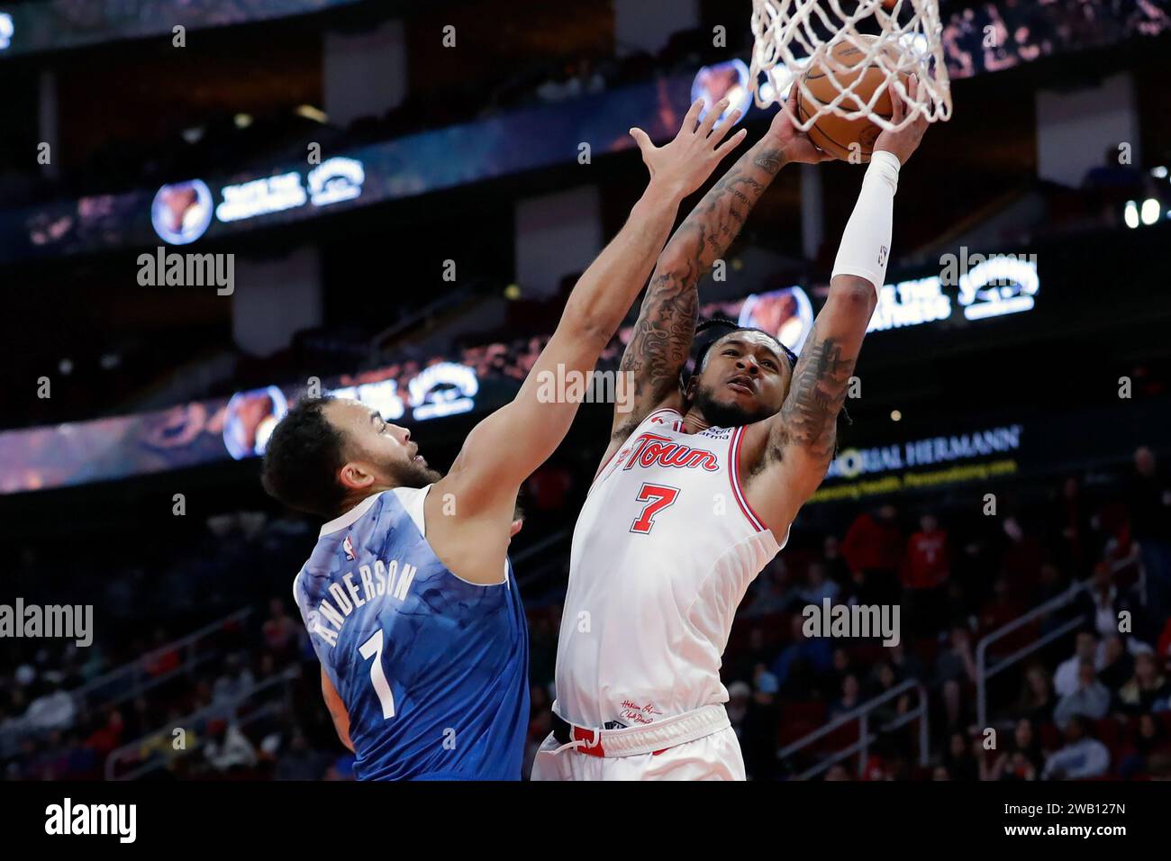 Houston Rockets forward Cam Whitmore, right, lays up a shot past ...