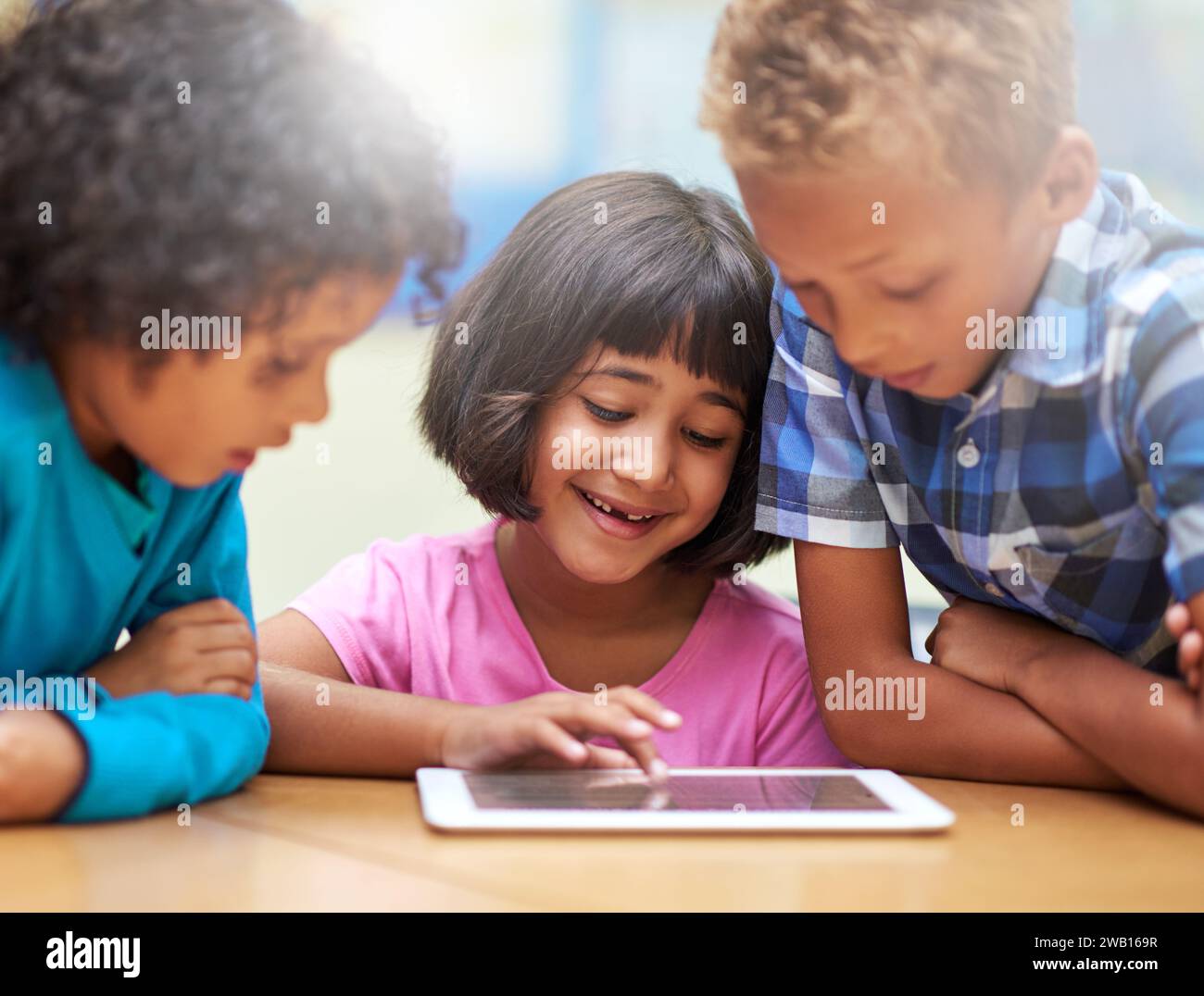 Students, kids learning and tablet in classroom for online education ...