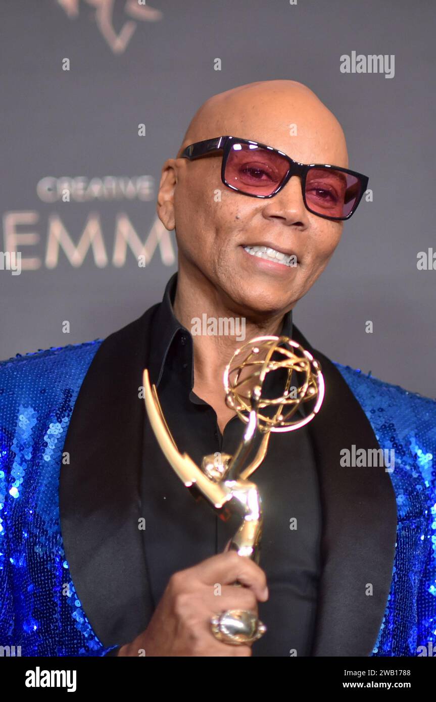RuPaul poses in the press room with the award for outstanding host for ...