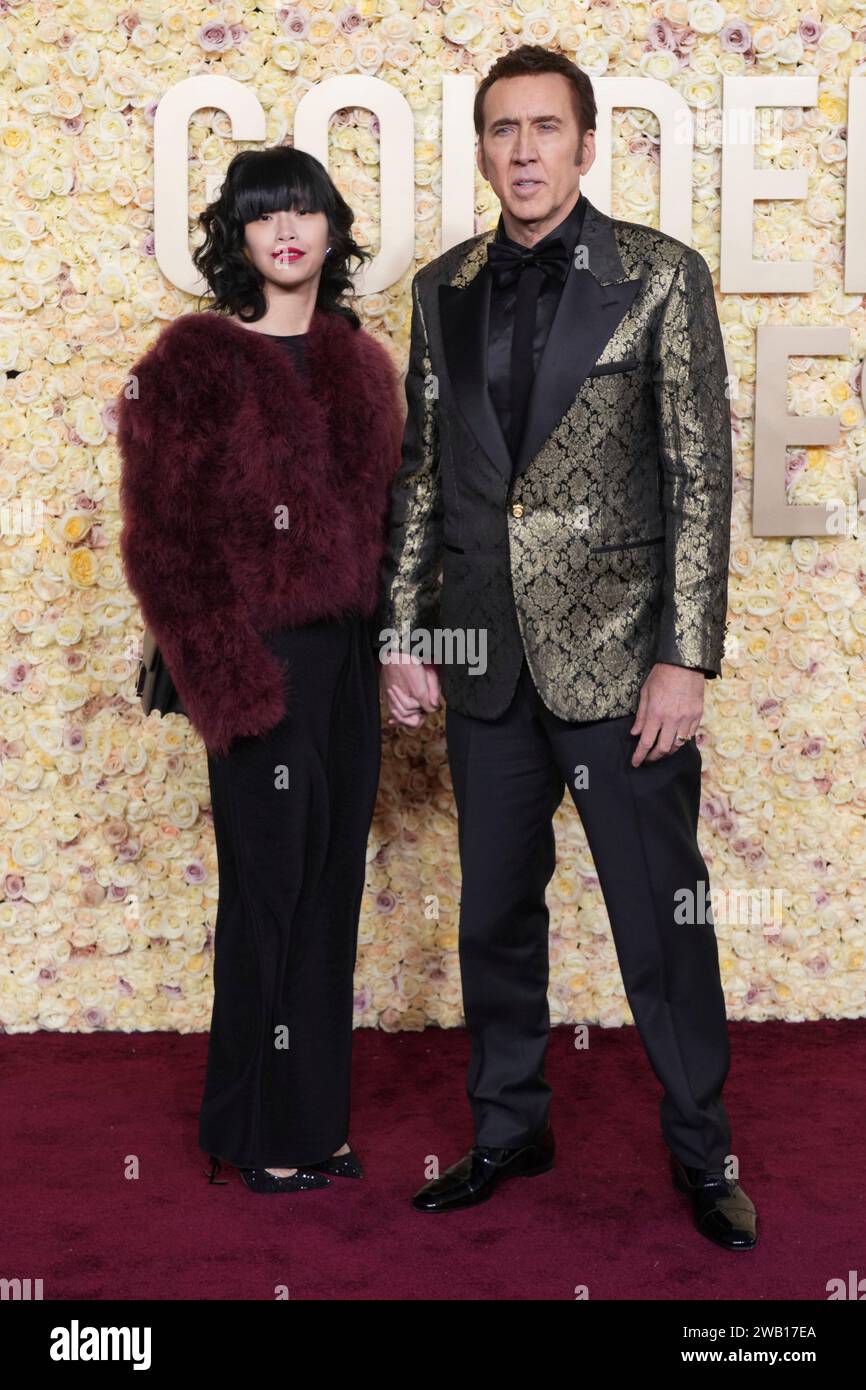 Riko Shibata, left, and Nicolas Cage arrive at the 81st Golden Globe ...