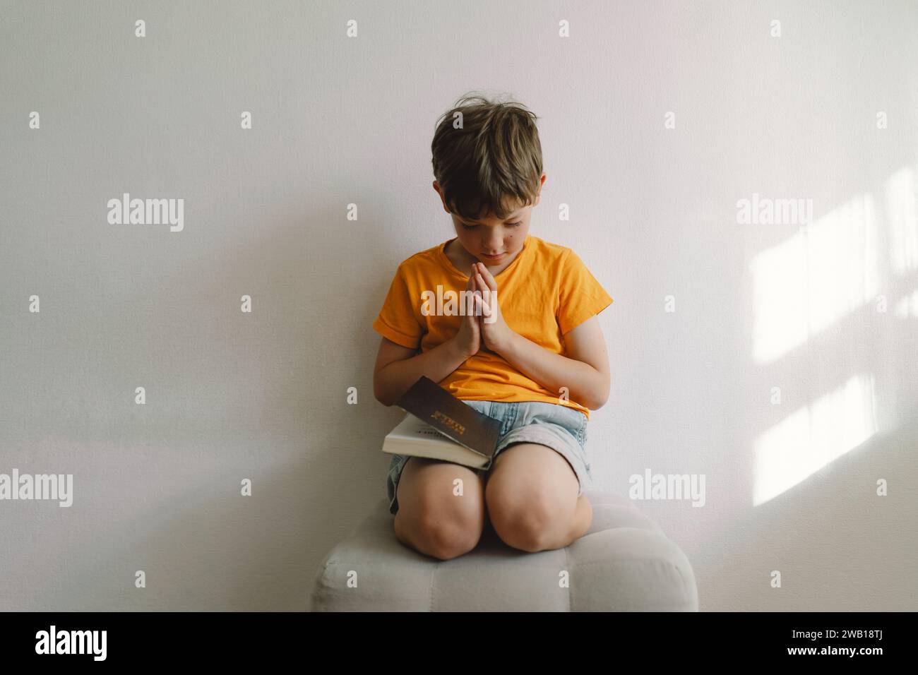 Christian boy holds bible in her hands. Reading the Holy Bible Stock ...