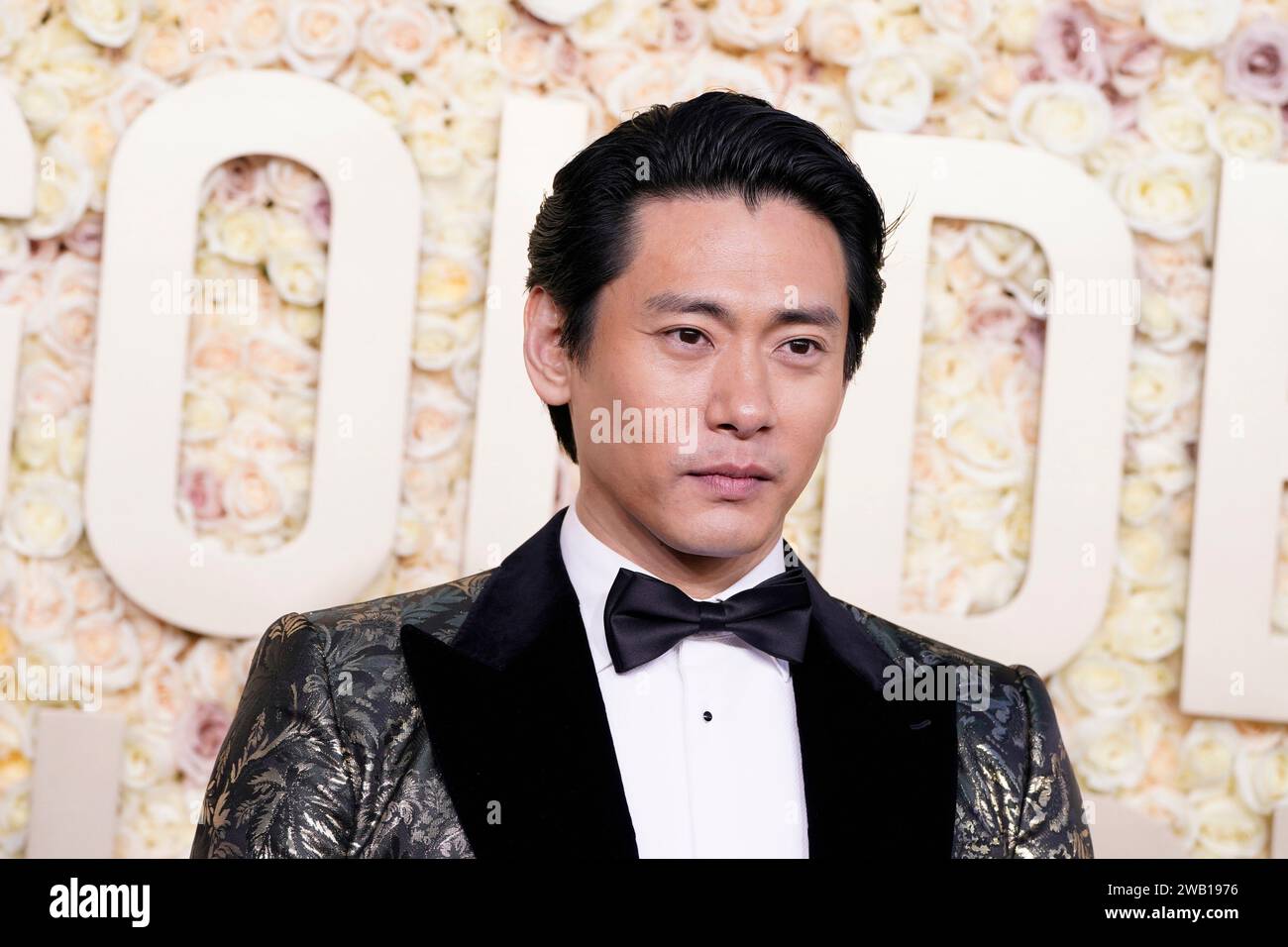 Teo Yoo arrives at the 81st Golden Globe Awards on Sunday, Jan. 7, 2024 ...
