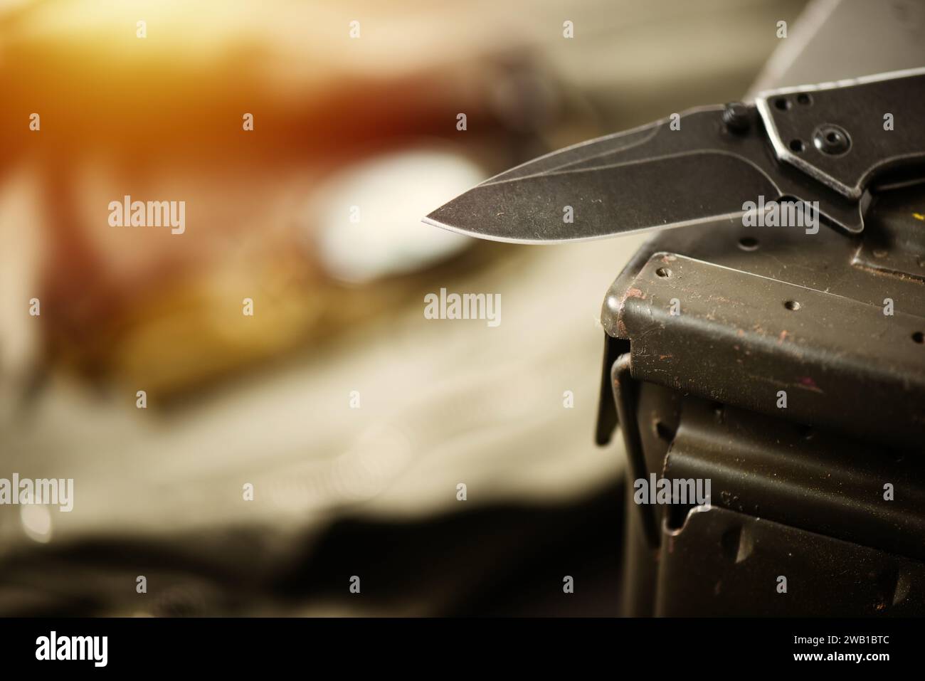 stainless steel pocketknife with military objects in the background ...