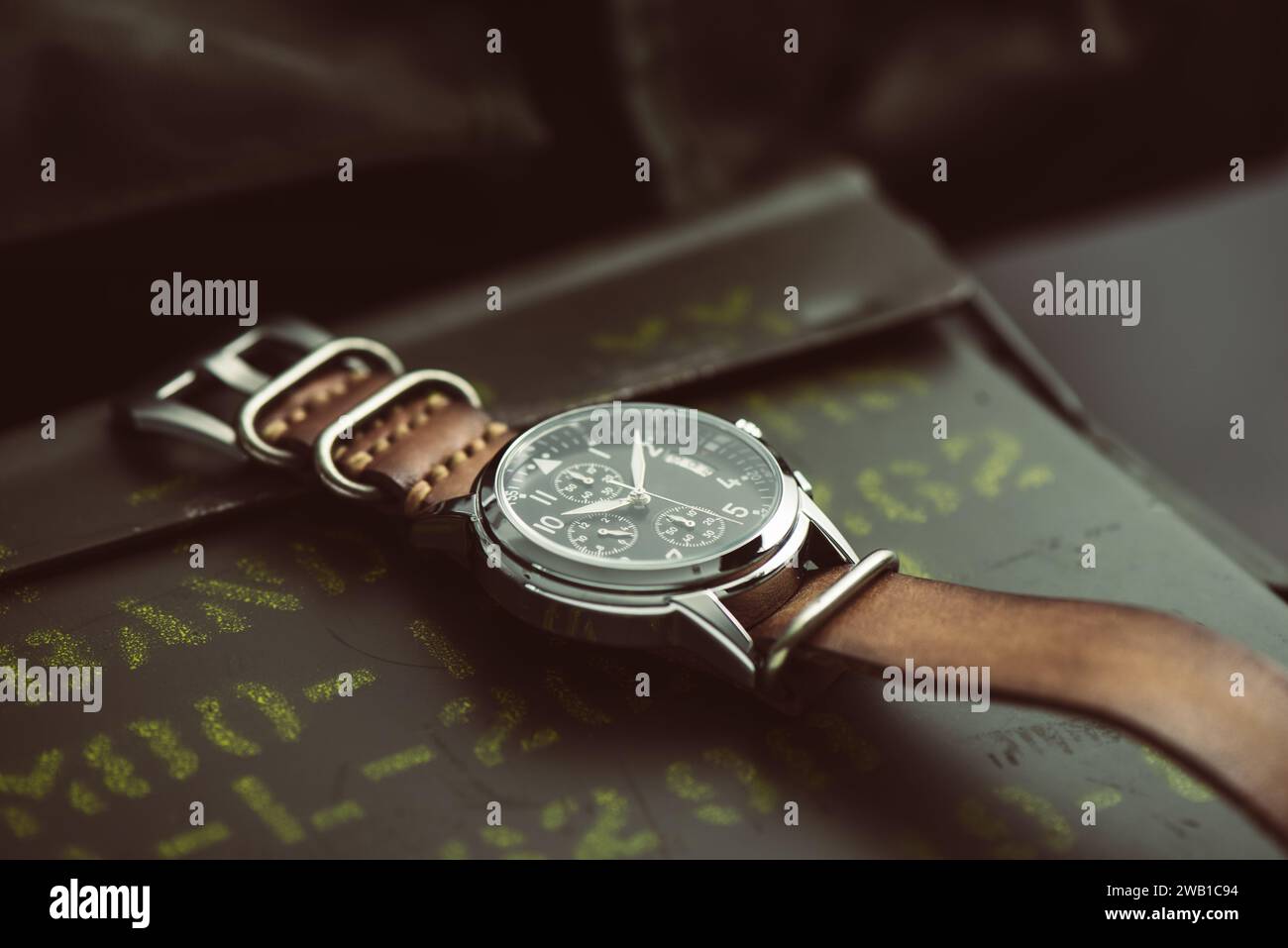 Close up black dial military style wristwatch with leather watch band ...