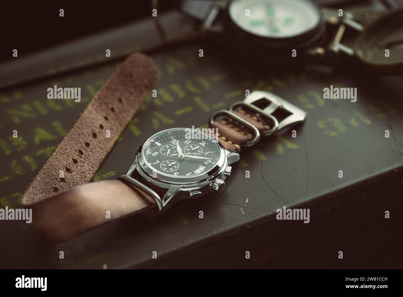 Close up black dial military style wristwatch with leather watch band ...