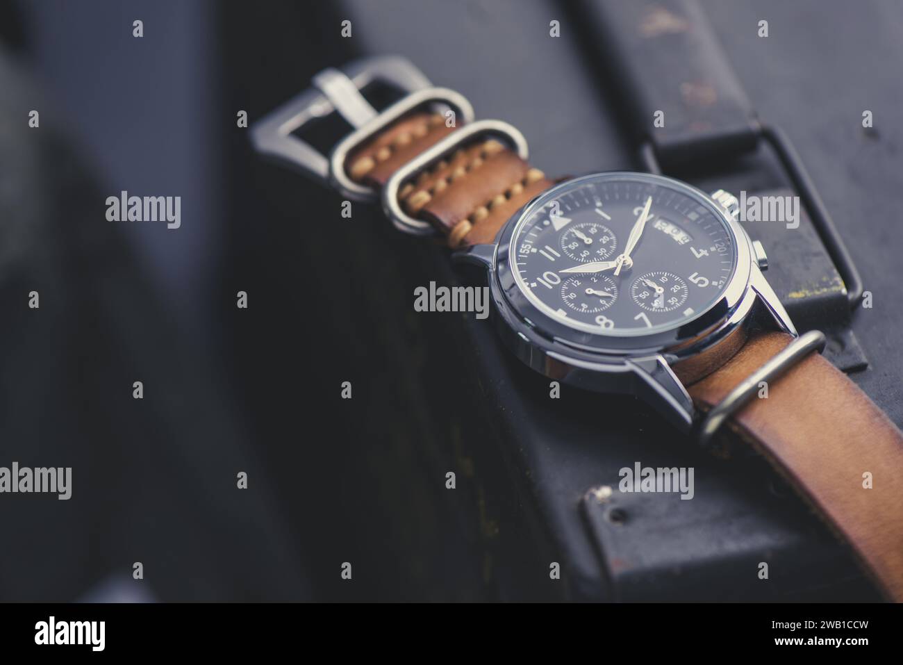Close up black dial military style wristwatch with leather watch band ...