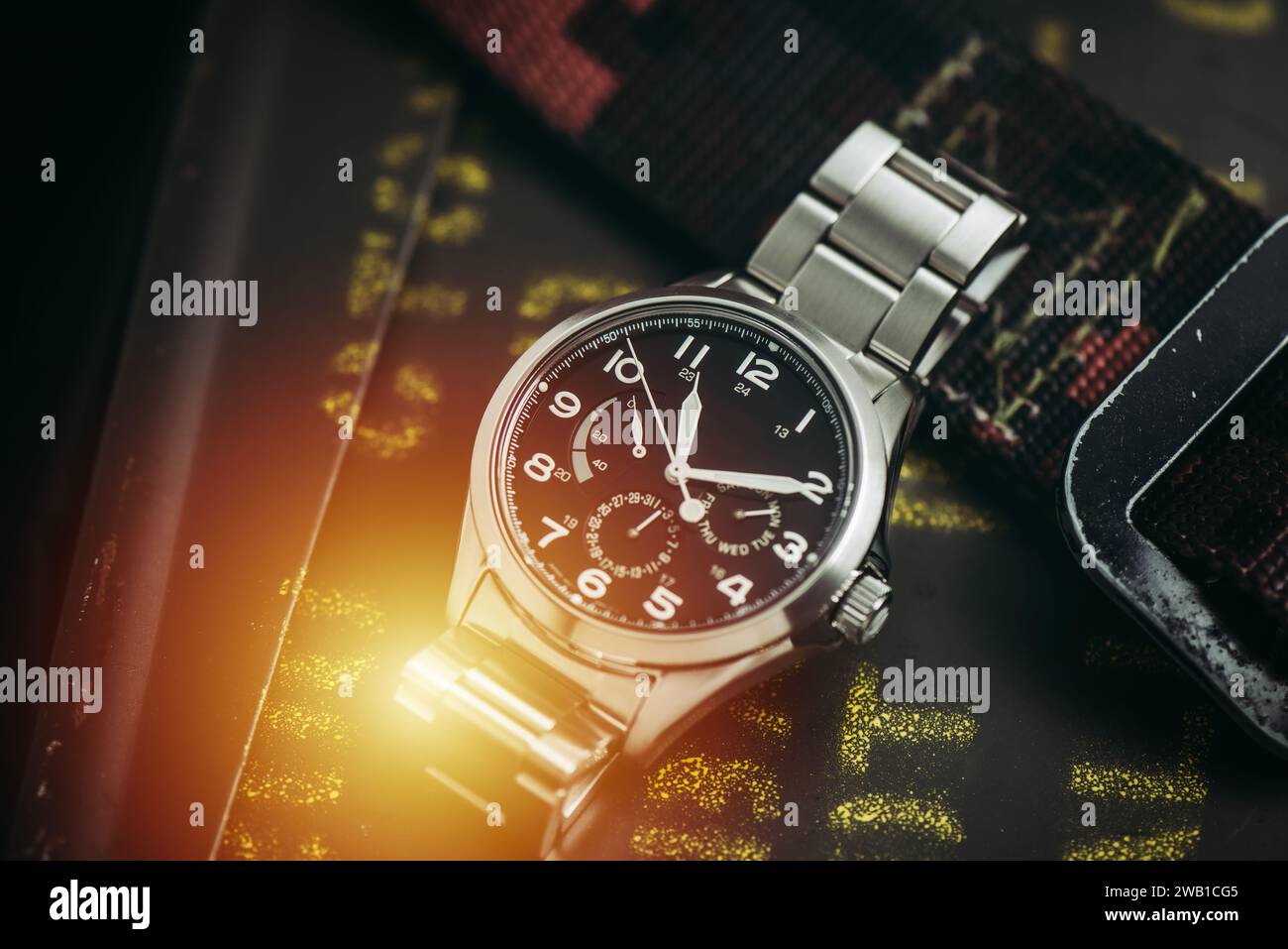 Close up black dial military style wristwatch with stainless steel ...