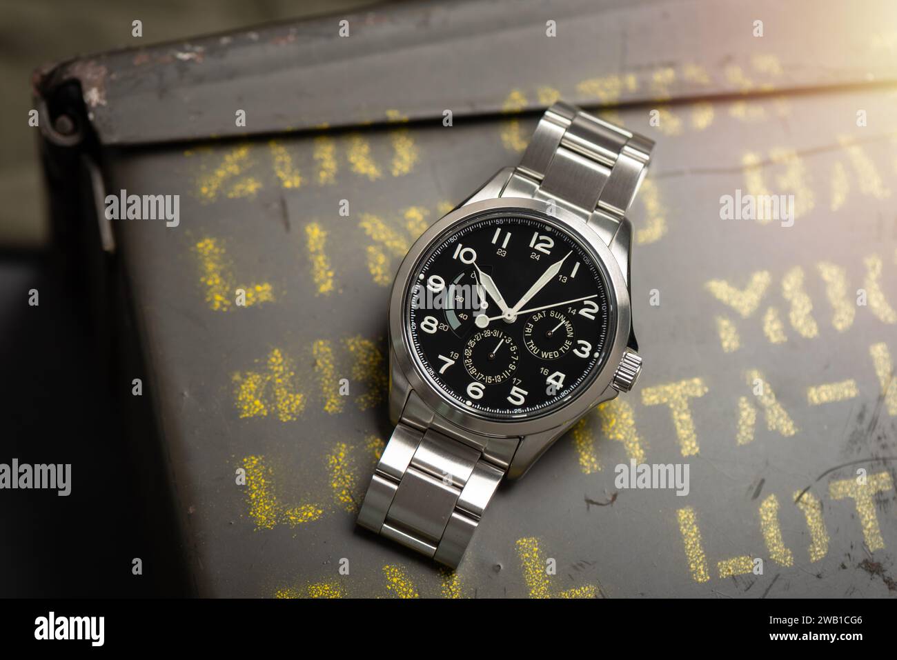 Close up black dial military style wristwatch with stainless steel ...