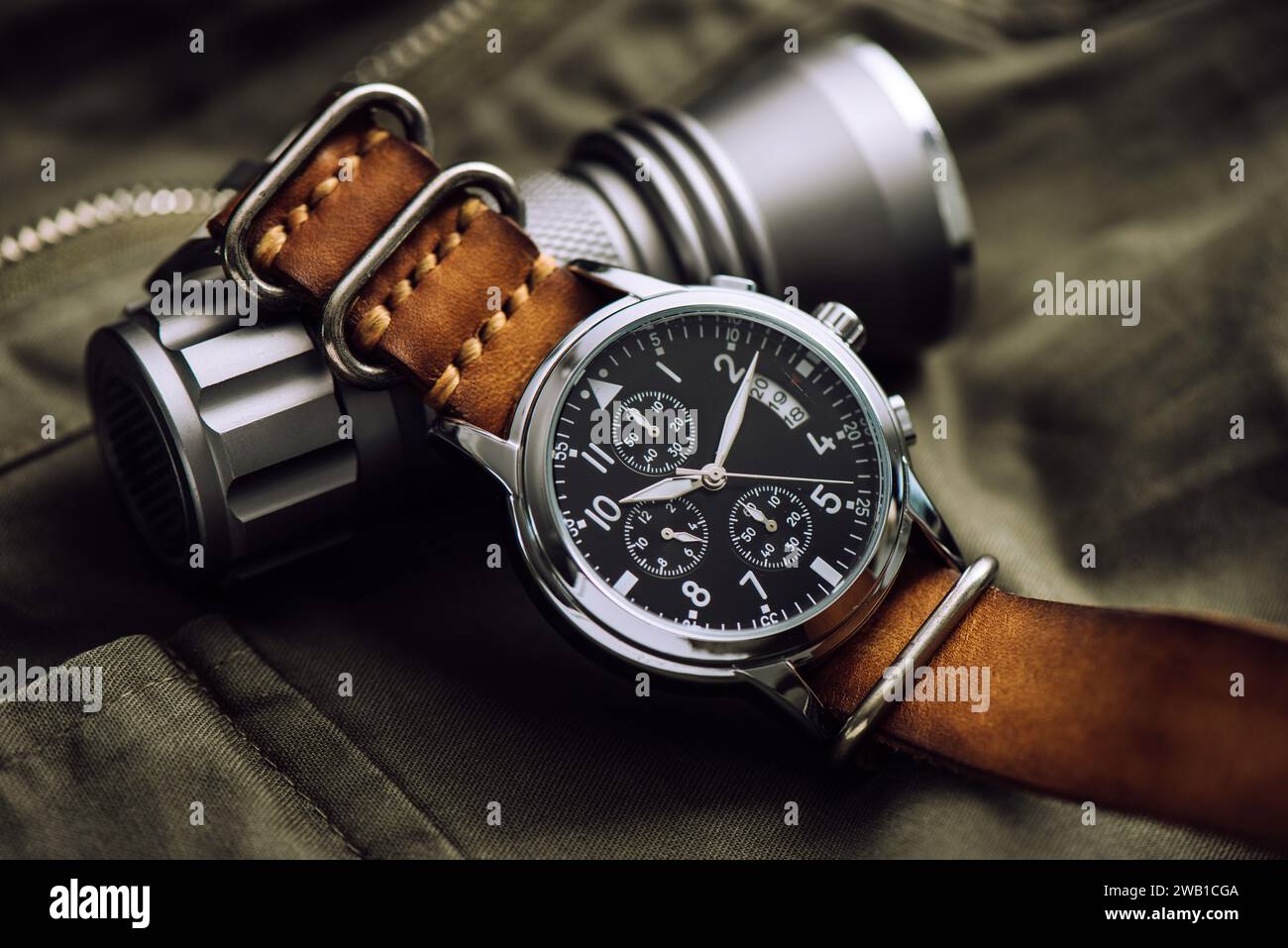 Close up black dial military style wristwatch with leather watch band ...
