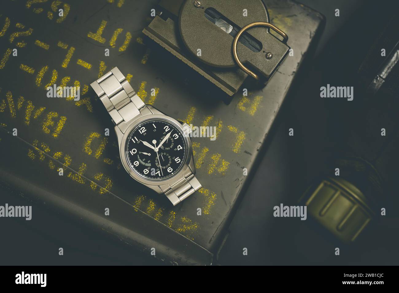 Close up black dial military style wristwatch with stainless steel ...