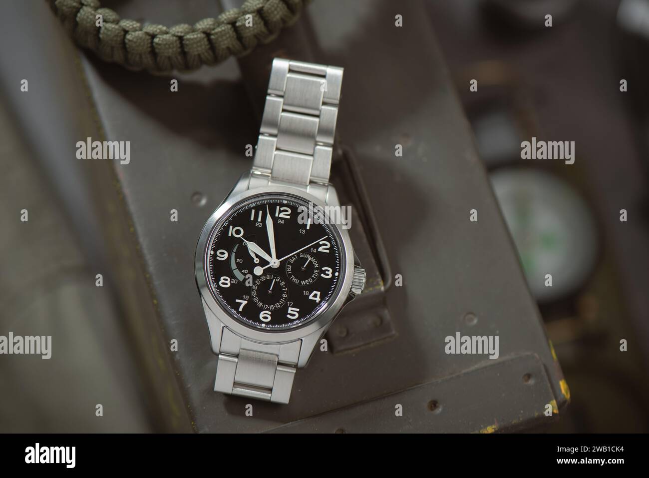 Close up black dial military style wristwatch with stainless steel ...