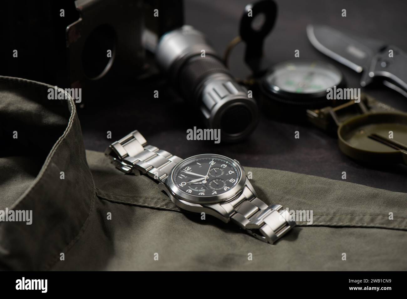 Close up black dial military style wristwatch with stainless steel ...