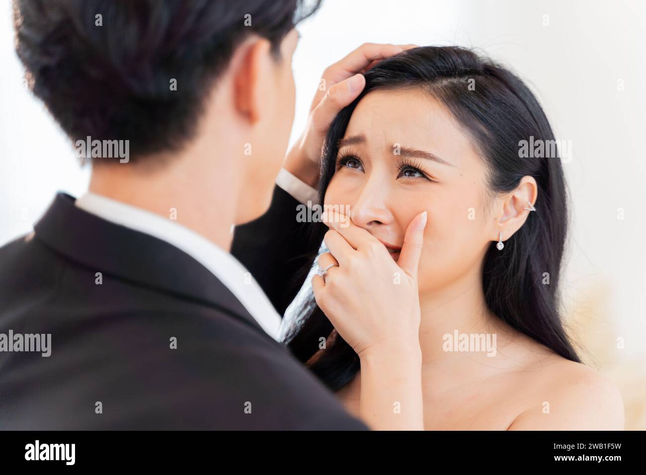 Emotional Asian bride tears up in tender moment with groom at their ...