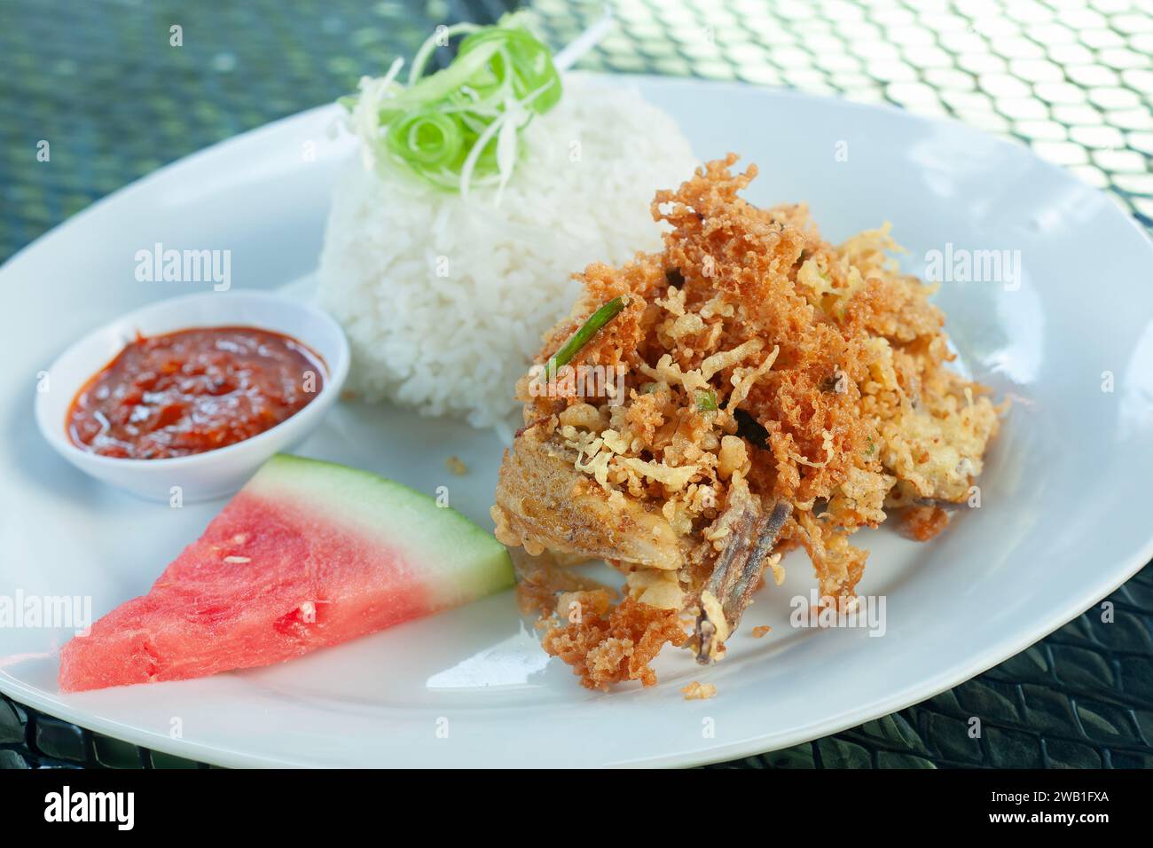 Crispy chicken rice with fruit and spicy sauce Stock Photo - Alamy