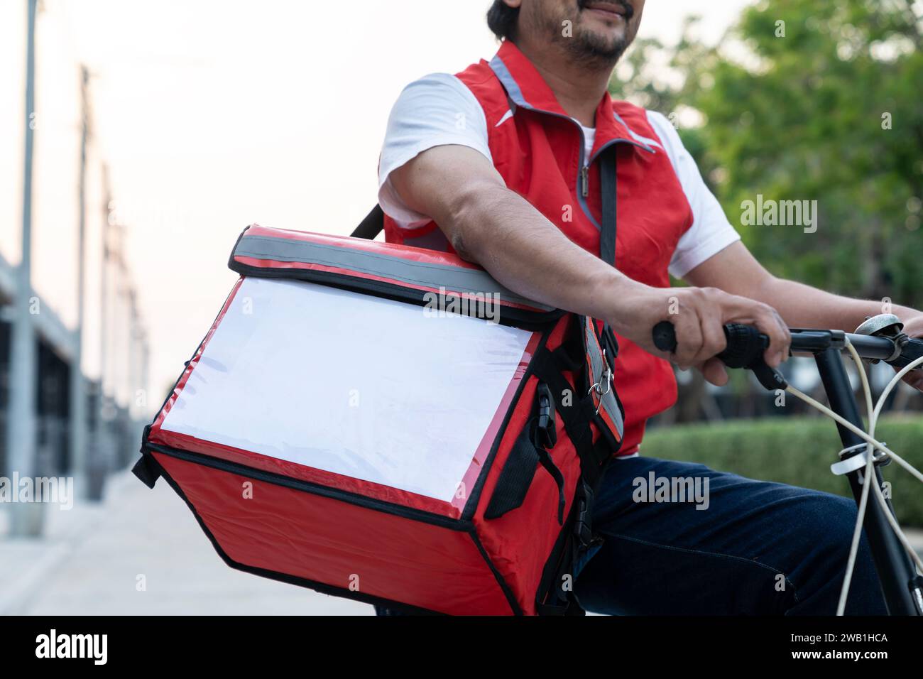 Delivery man with bicycle hi-res stock photography and images - Alamy