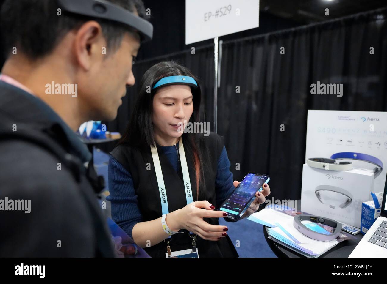 Kimi Doan, of Earable Neuroscience, right, demonstrates the FRENZ ...