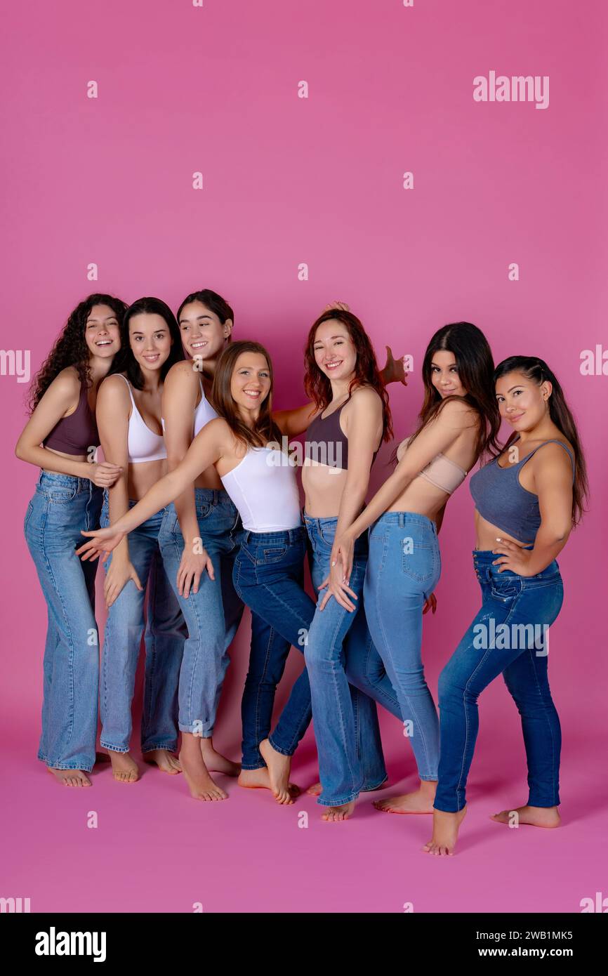 A group of friendly women in various denim styles united and posing ...