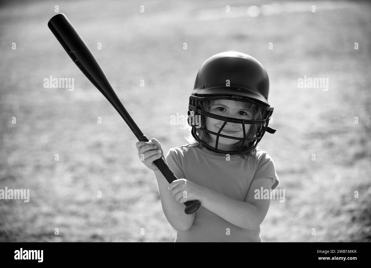 Little child baseball player focused ready to bat. Kid holding a ...