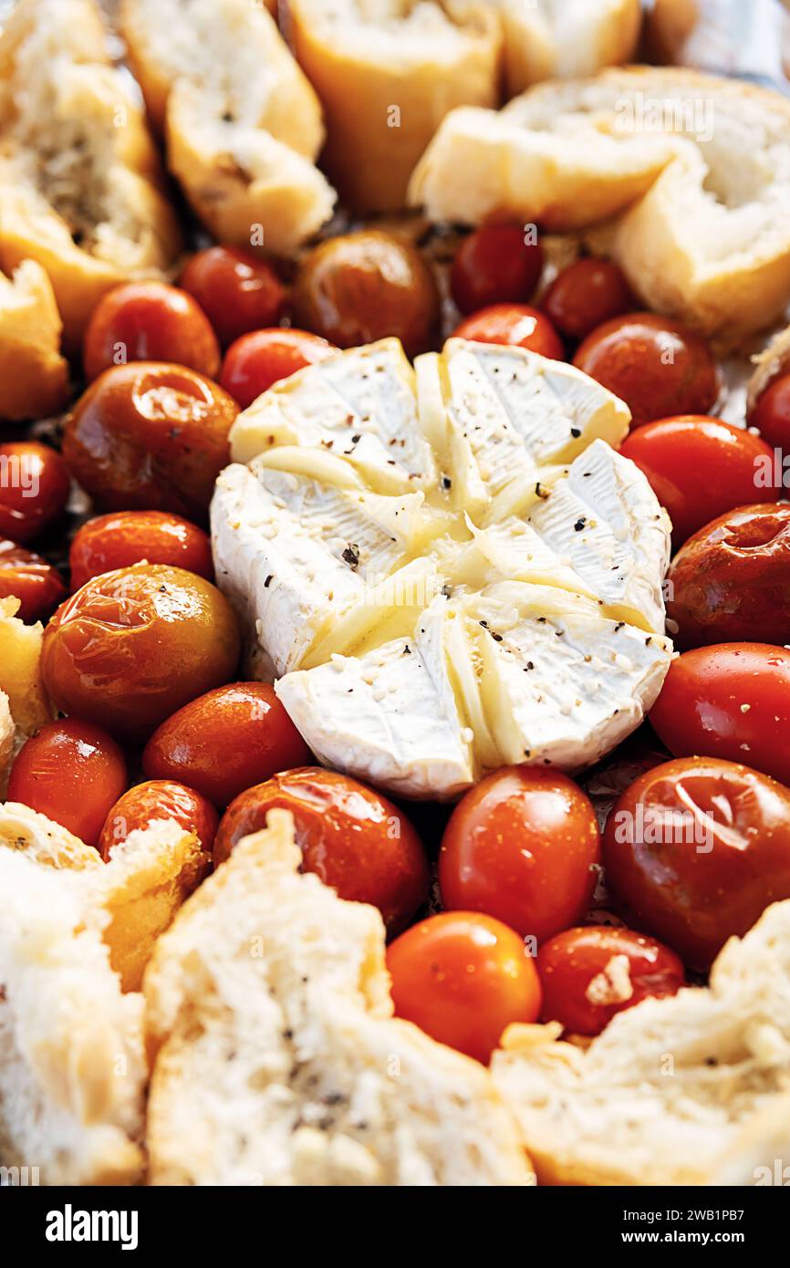 Camembert cheese baked with tomatoes and baguette Stock Photo - Alamy