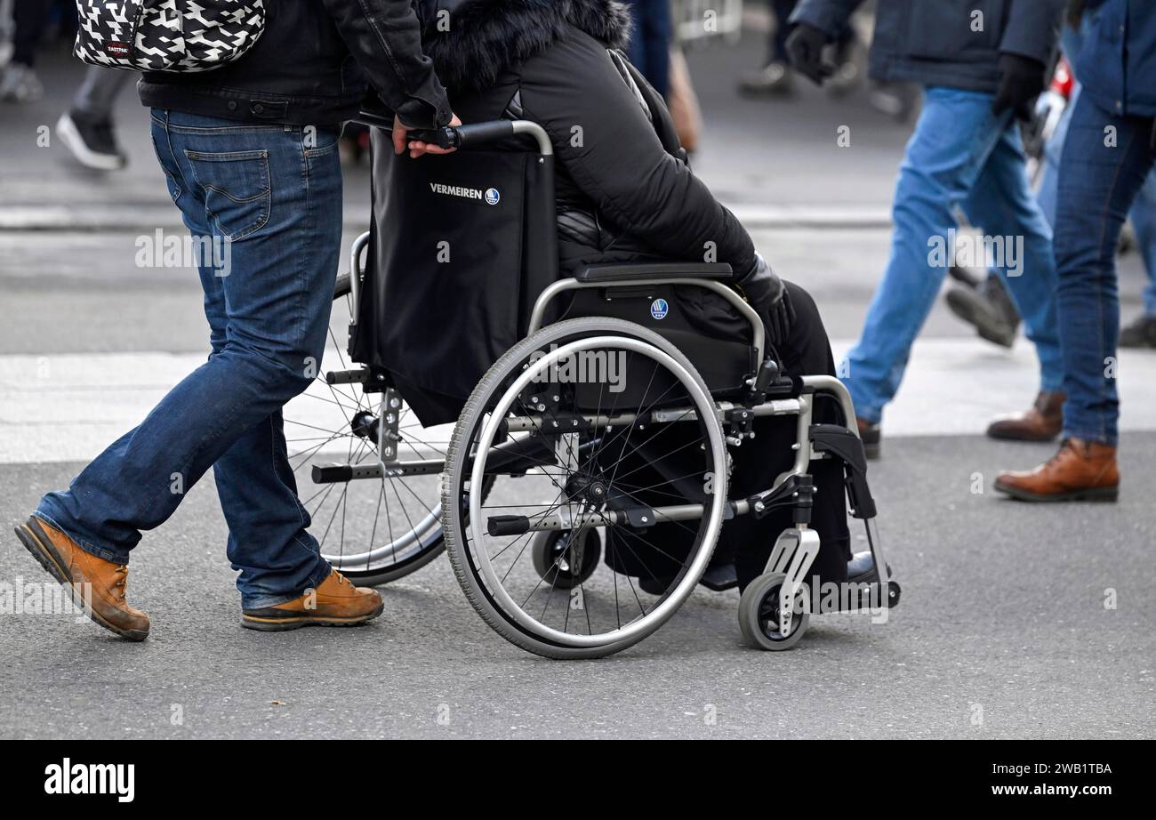 Symbol photo Man pushing wheelchair Stock Photo - Alamy