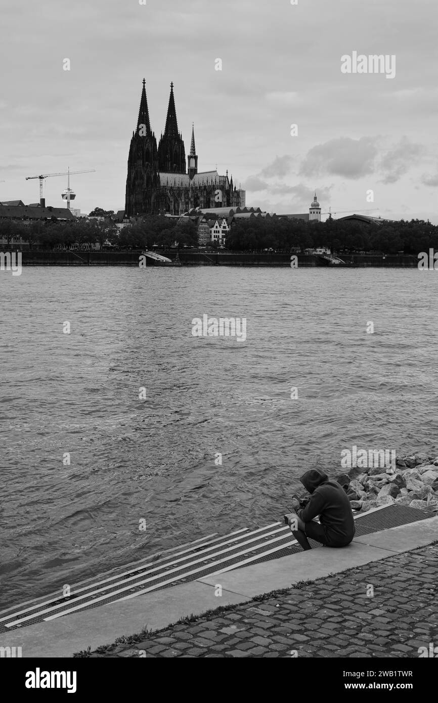 View over the Rhine with cathedral and lone person in front of it ...