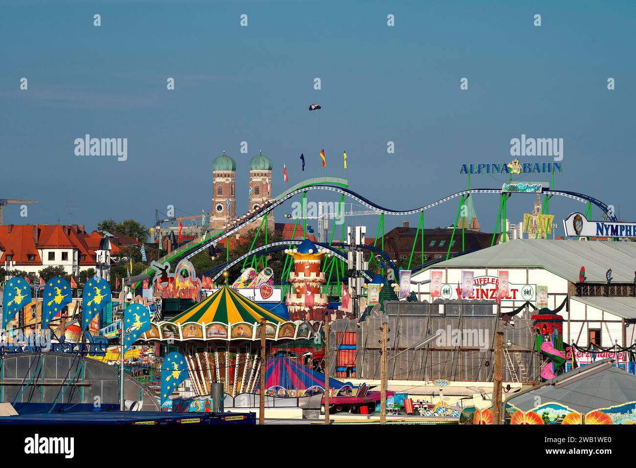 Oktoberfest, afternoon with alpine railway in front of the Church of ...