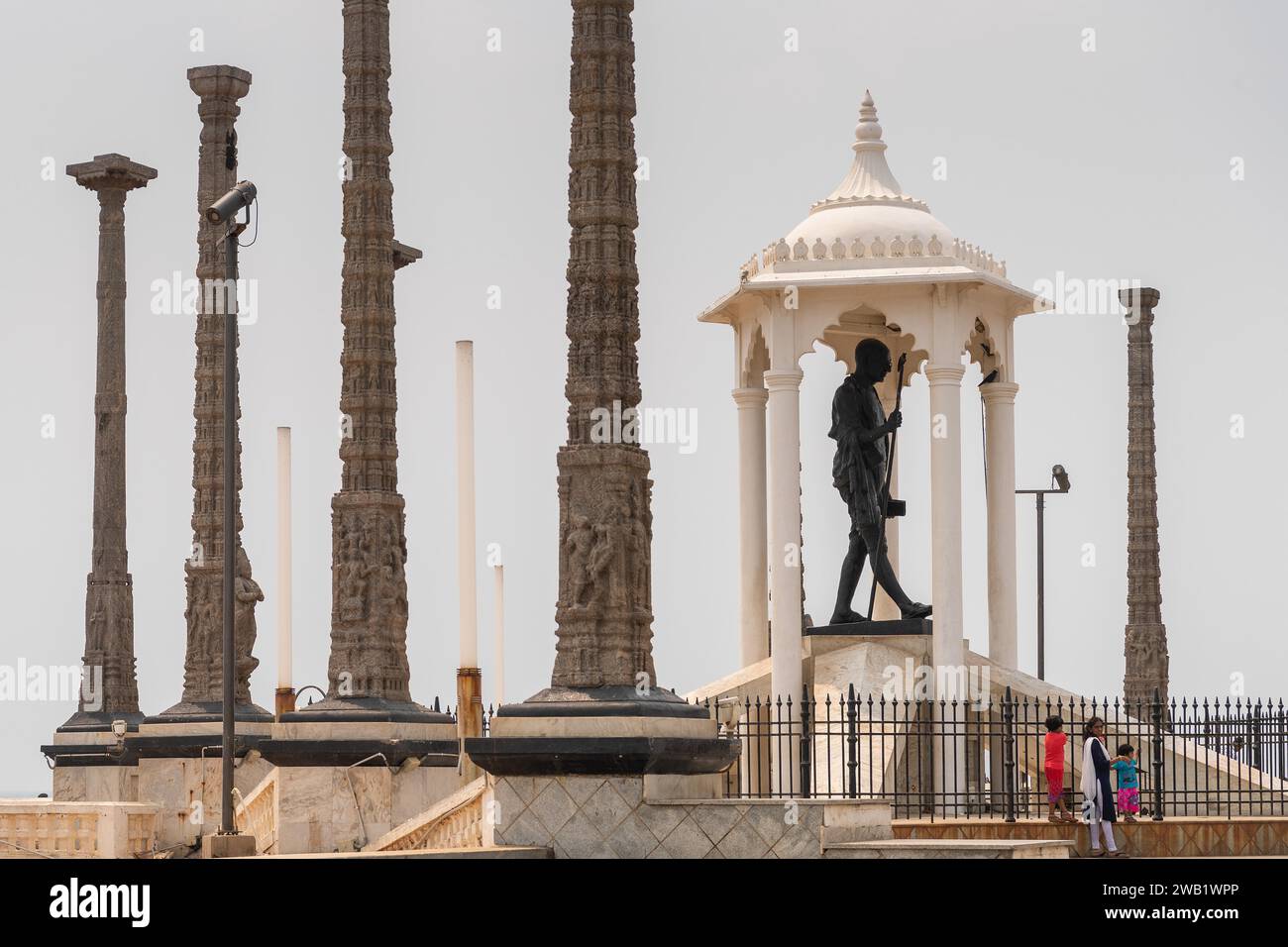 Child at the foot of a Mahatma Gandhi monument, statue, former French ...