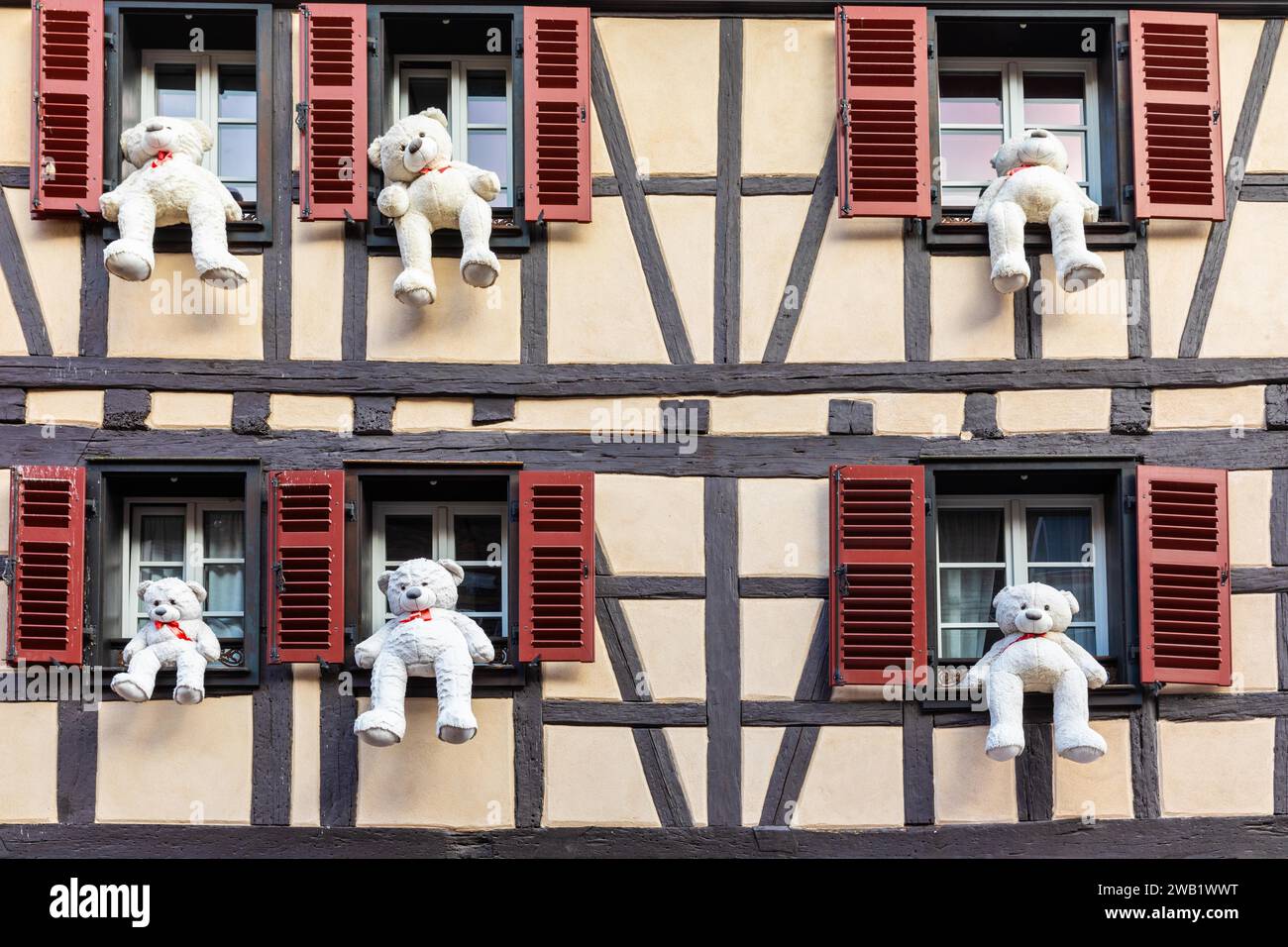 Teddy bears sitting in the window of a half-timbered house, Christmas ...