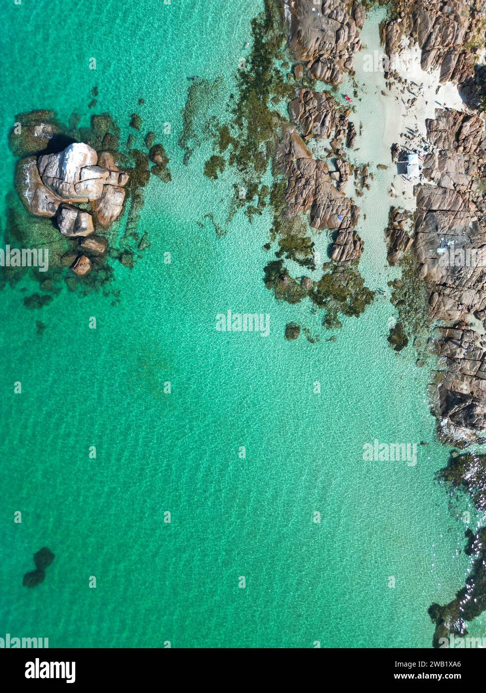 An aerial view of an island surrounded by ocean waters, with rocky ...