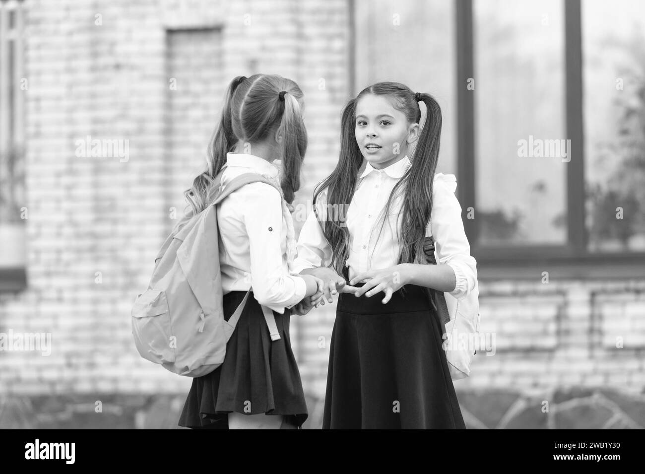 two school girls friends talking together outdoor Stock Photo - Alamy